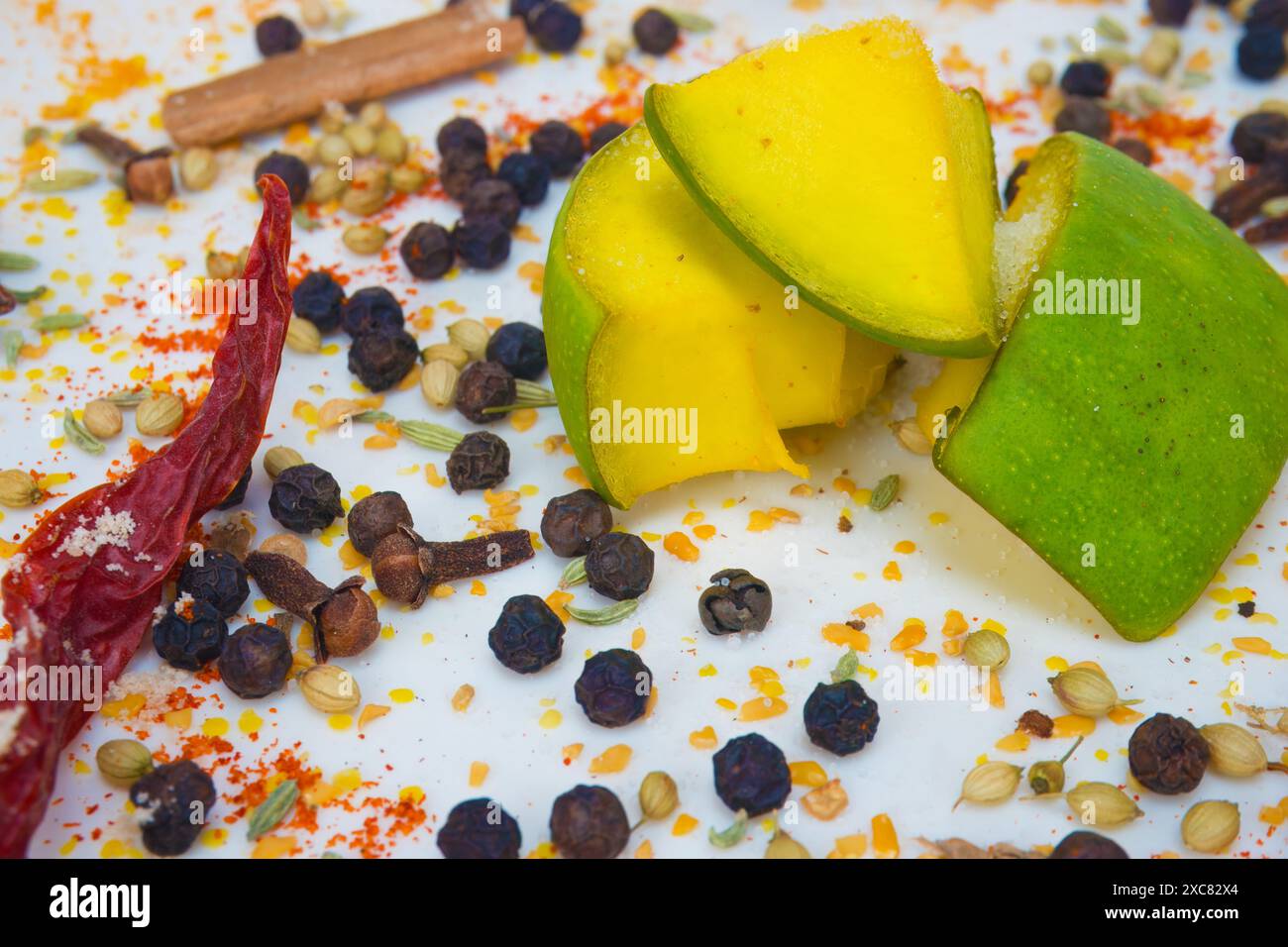 On a white plate Indian spices used in mango pickle is showcased. The ...