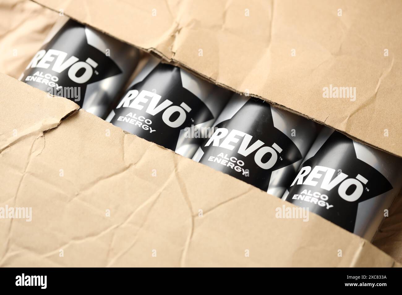 KYIV, UKRAINE - APRIL 20, 2024 Cans of Revo alco energy drink in new ...