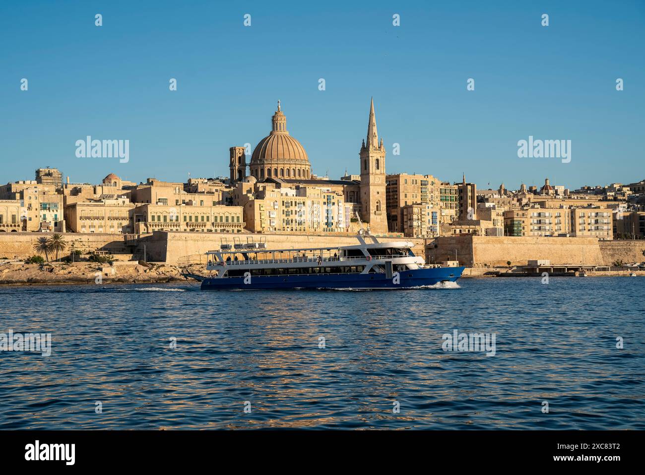 Sightseeing cruise boat goes to the harbor. Aerial cityscape about the ...