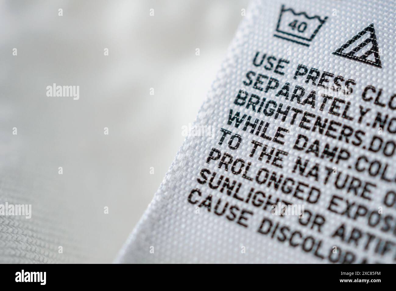 Cloth label tag with laundry care instructions Stock Photo - Alamy