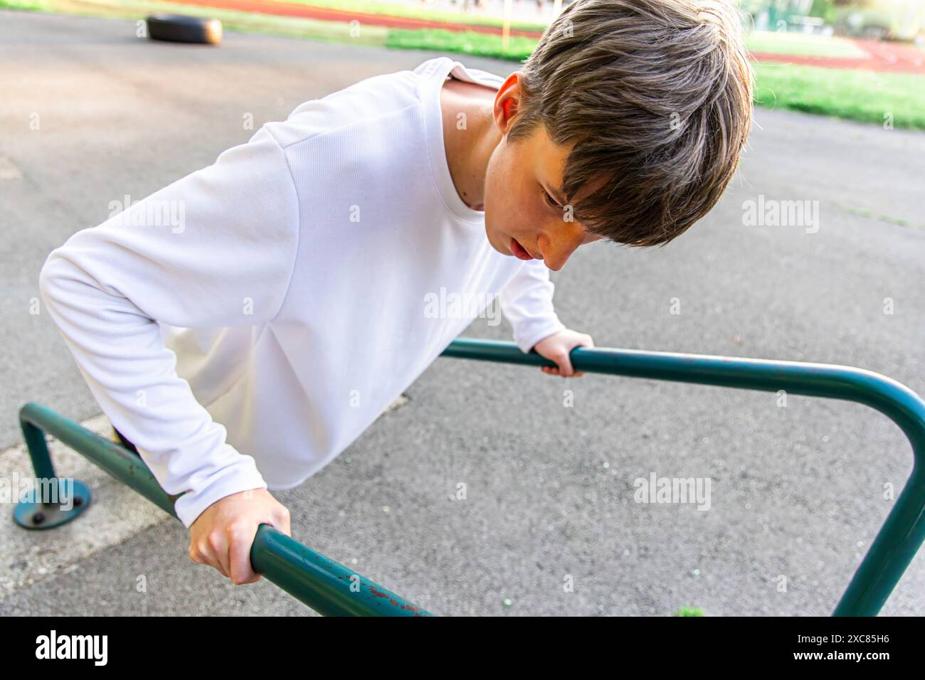 Young Man Performing Dips on Parallel Bars at Outdoor Gym Stock Photo ...