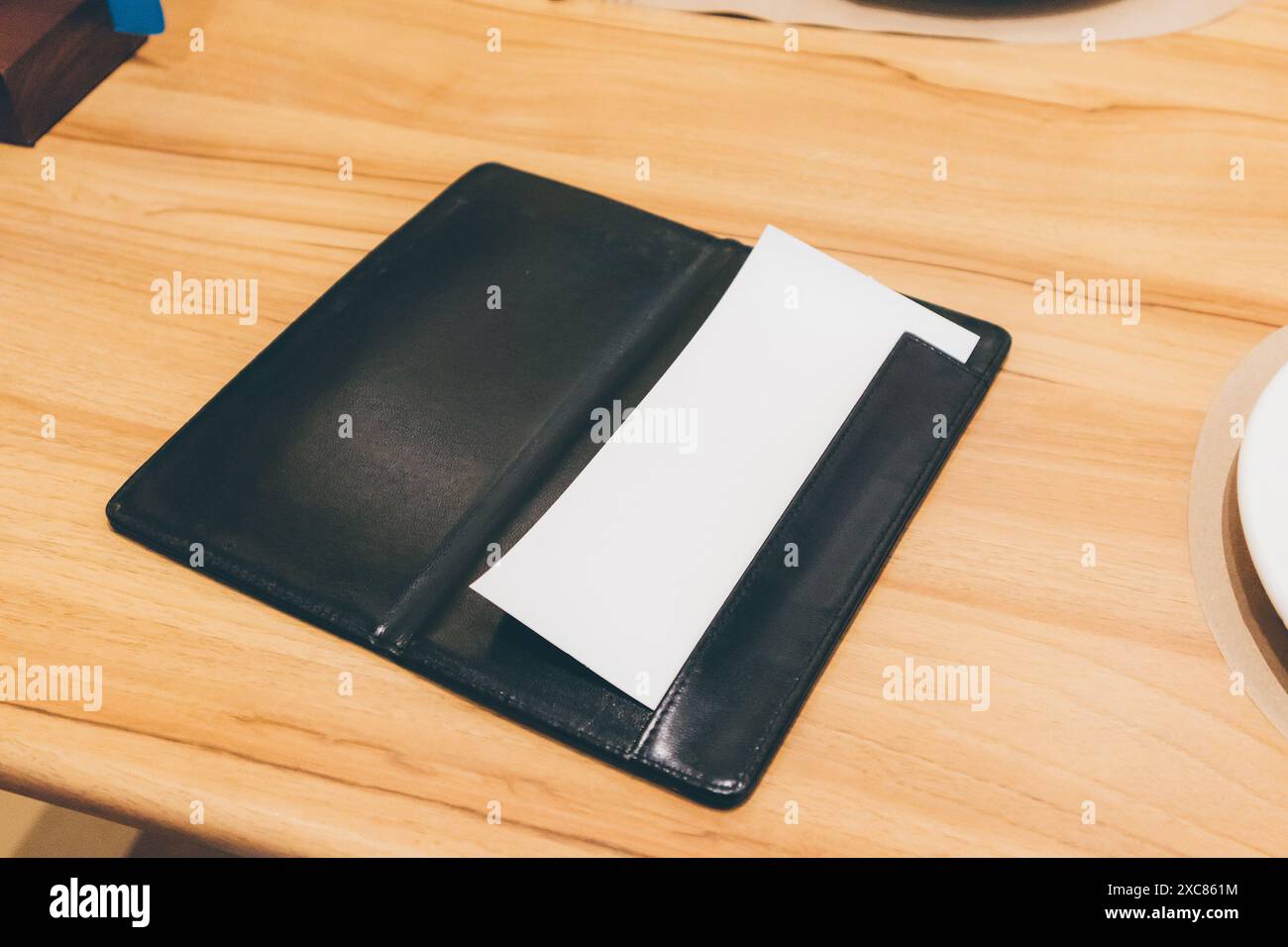 Blank empty white paper in restaurant payment billing receipt folder on ...