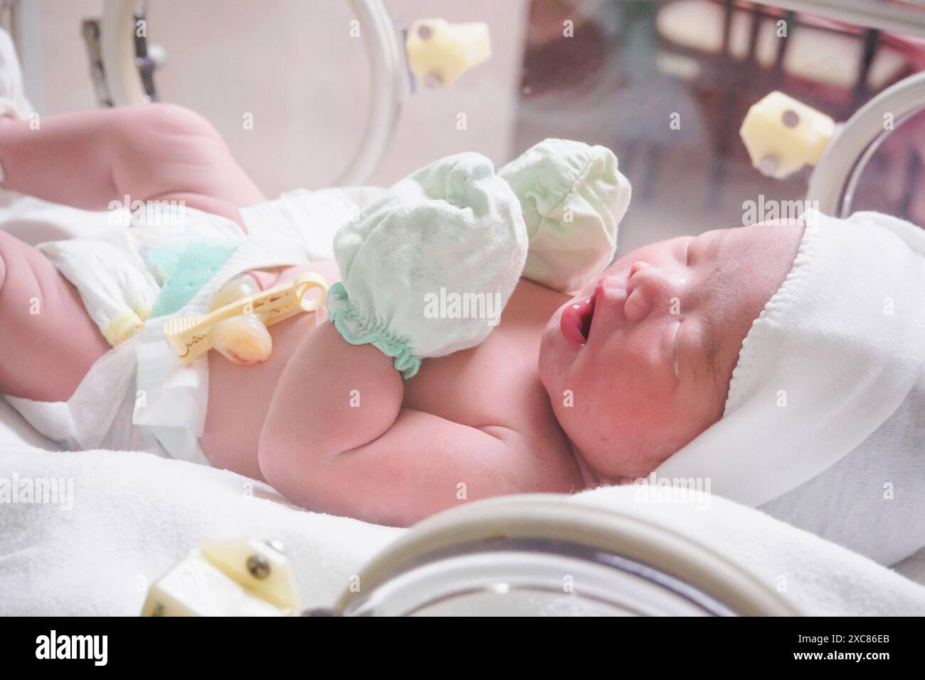 Newborn baby girl inside incubator in hospital post delivery room Stock ...