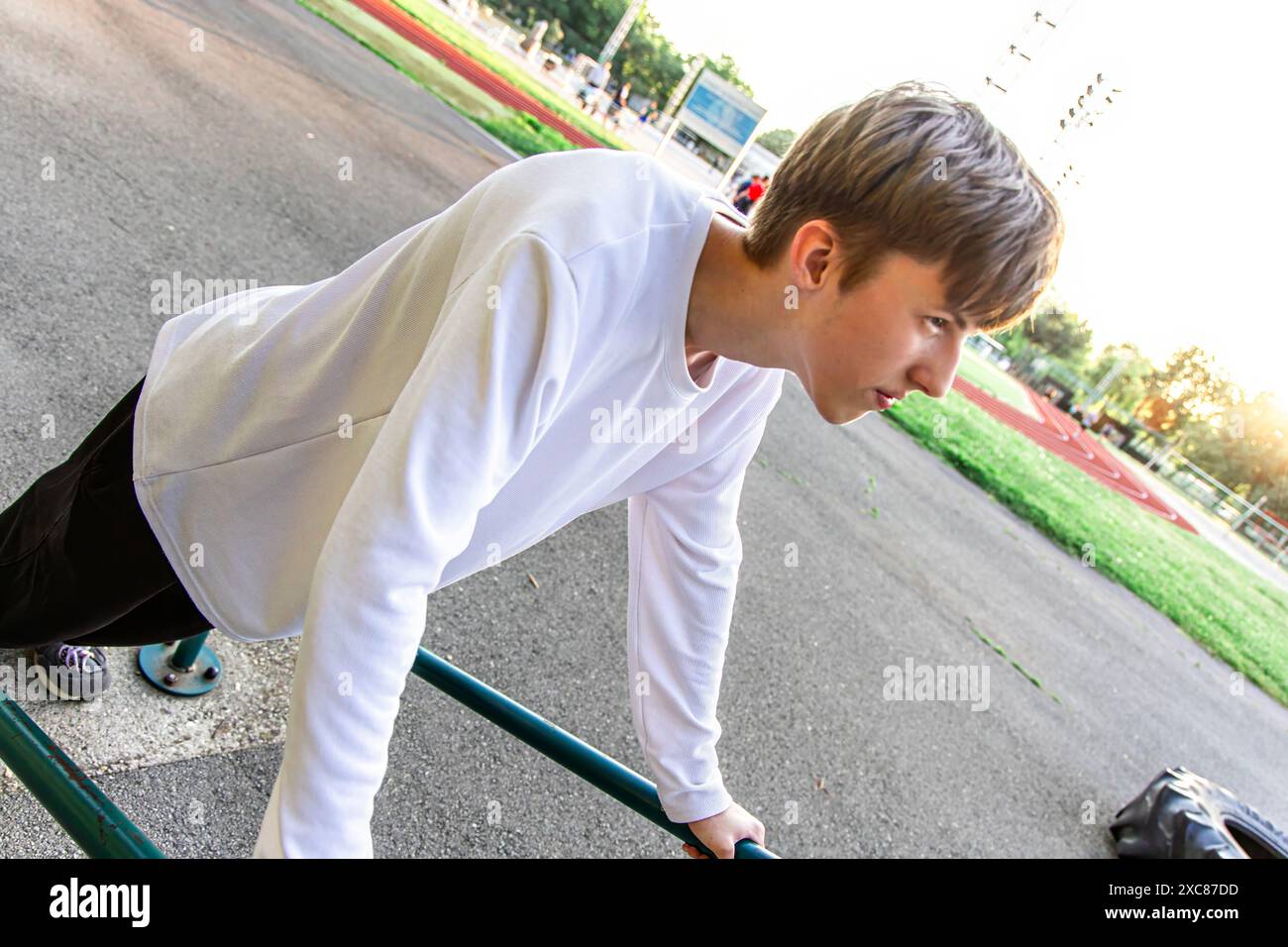 Young Man Performing Dip Exercise on Parallel Bars at Outdoor Gym Stock ...