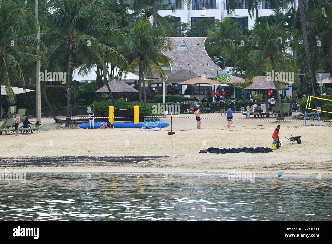 Singapore. 15th June, 2024. A worker removes a bag filled with oil ...