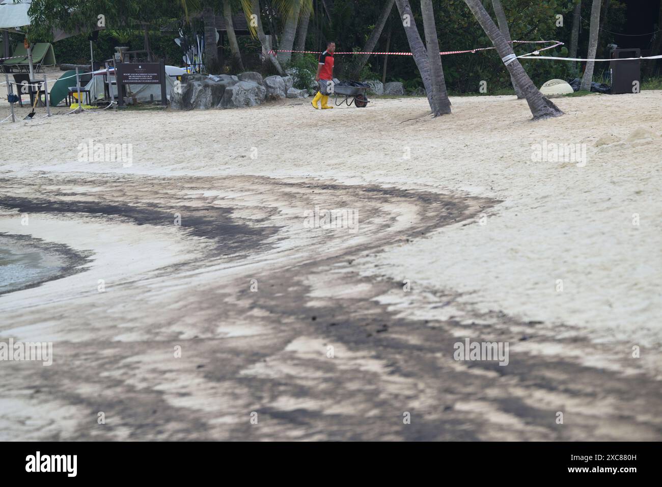 Singapore. 15th June, 2024. Oil stains are seen on Siloso beach of ...