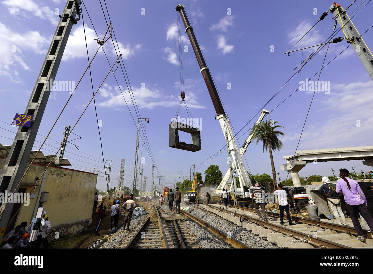 Ajmer, India. 15th June, 2024. Workers labor at the construction site ...