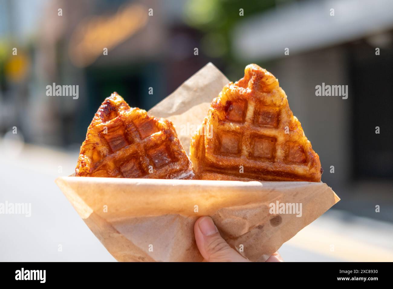 Hand holding Croffle, a hybrid of a croissant and waffle which is a ...