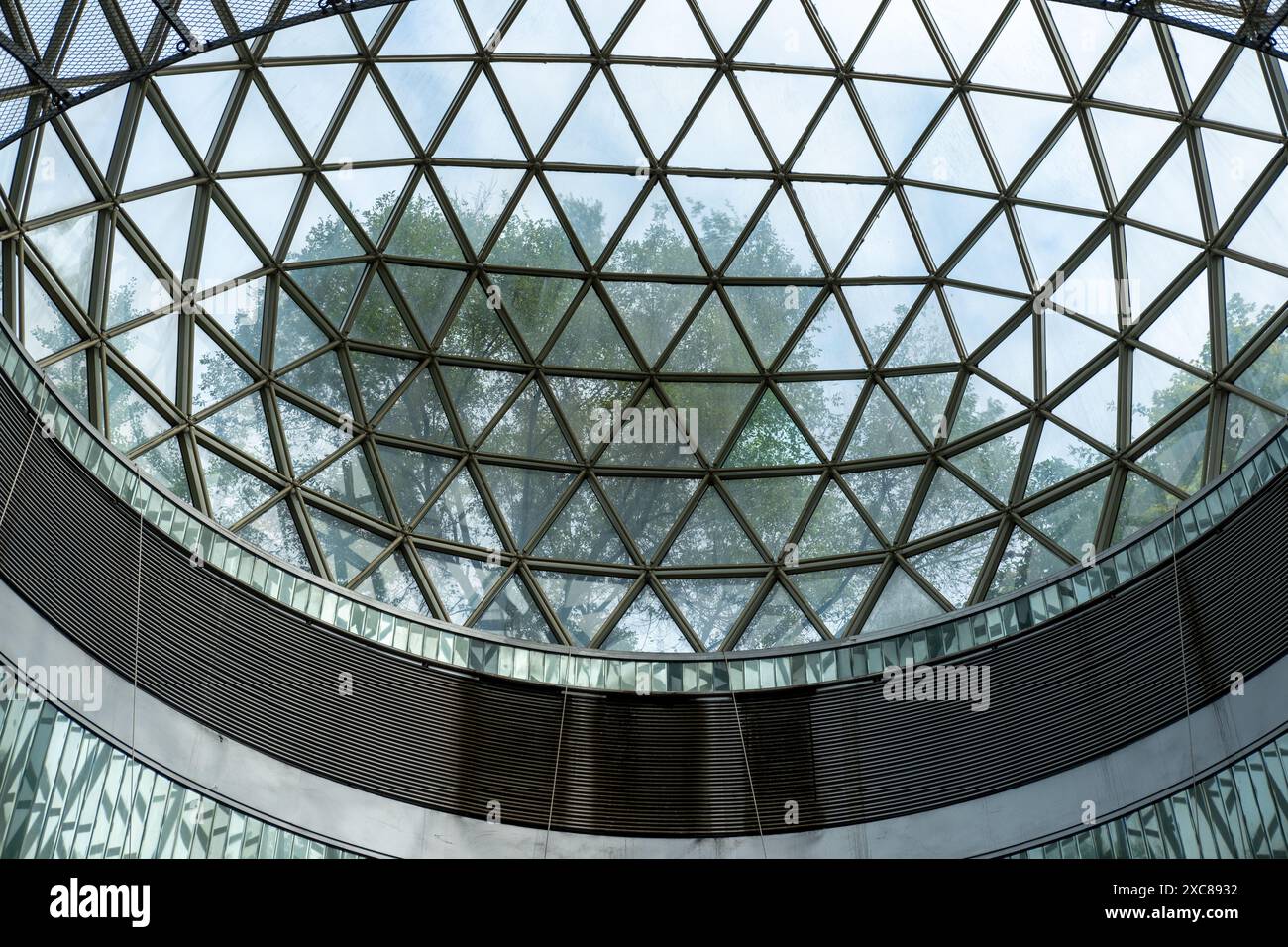 Detail of dome skylight structure roof view from below, with tree on ...