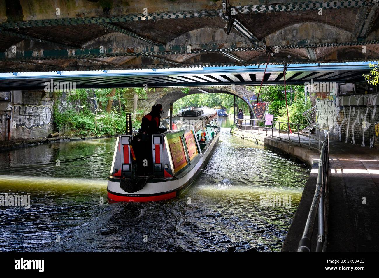London, UK. Barge passing under a bridge near Camden Lock on the Regents Canal Stock Photo - Alamy