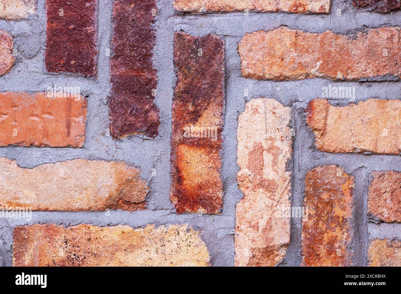 The image depicts a detailed view of a brick wall composed of various ...