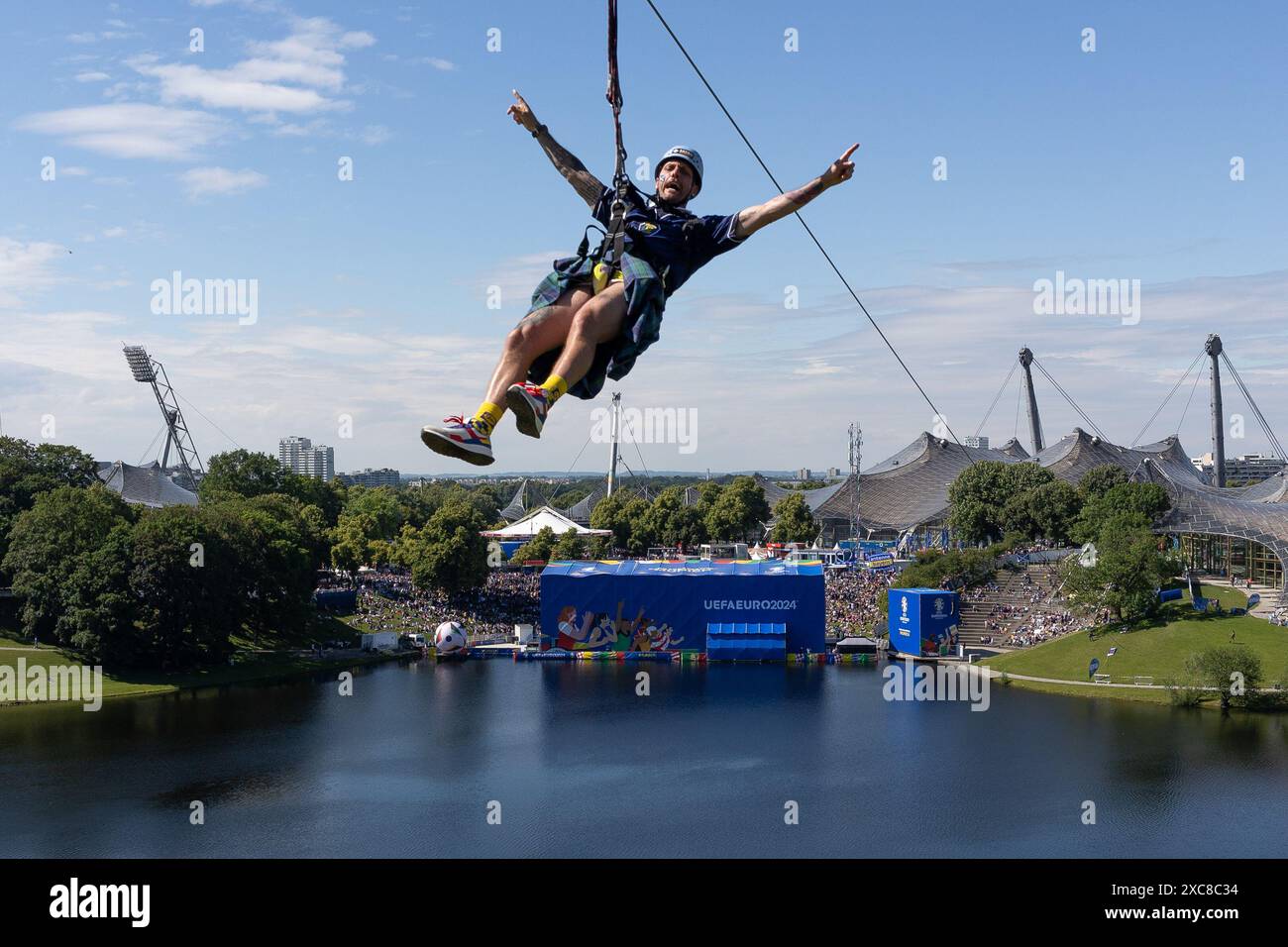 A Scotland fan singing "Flower of Scotland" descends on a zip wire over ...