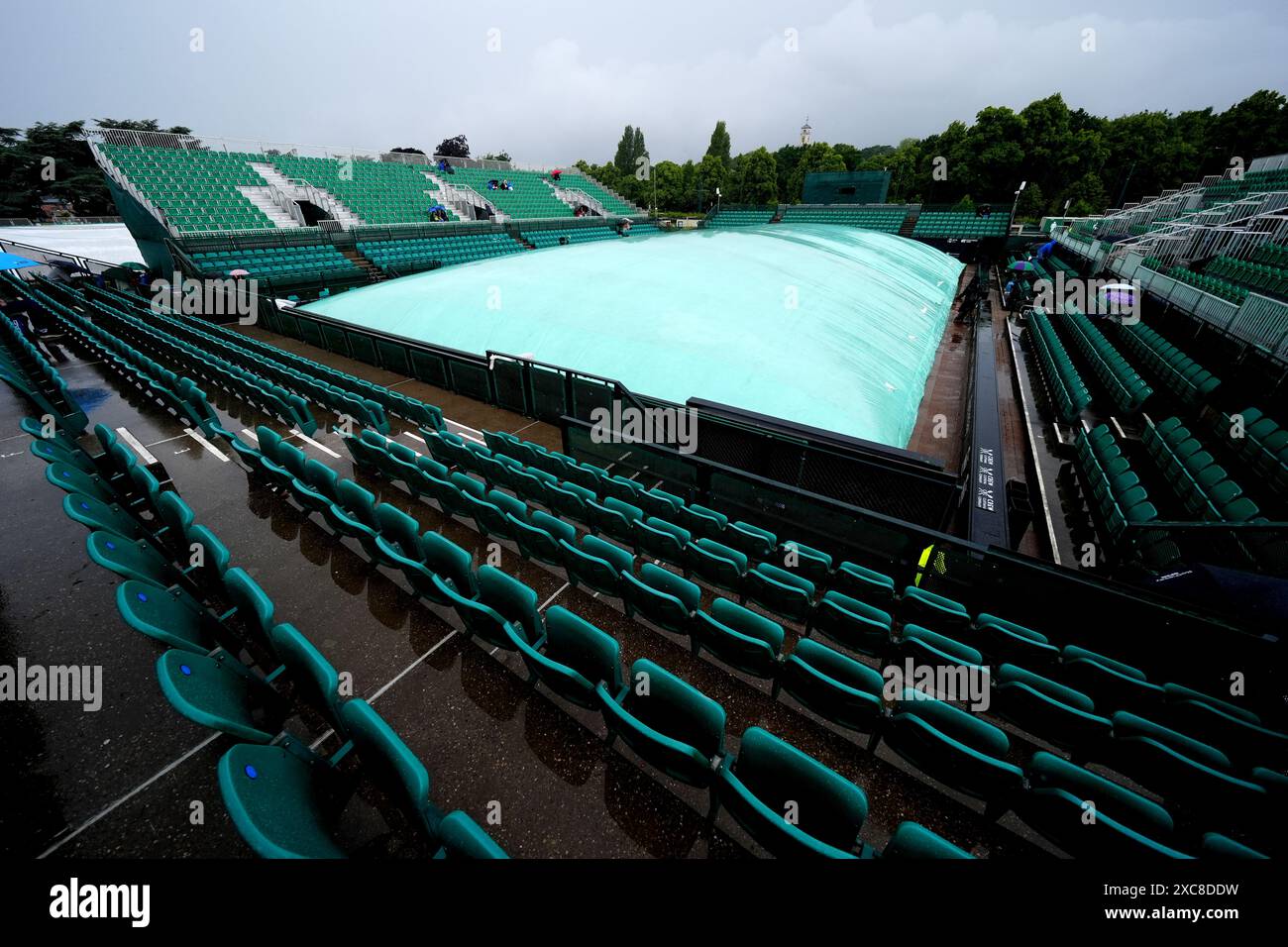 A rain cover on one of the courts as rain disrupts play on day six of ...
