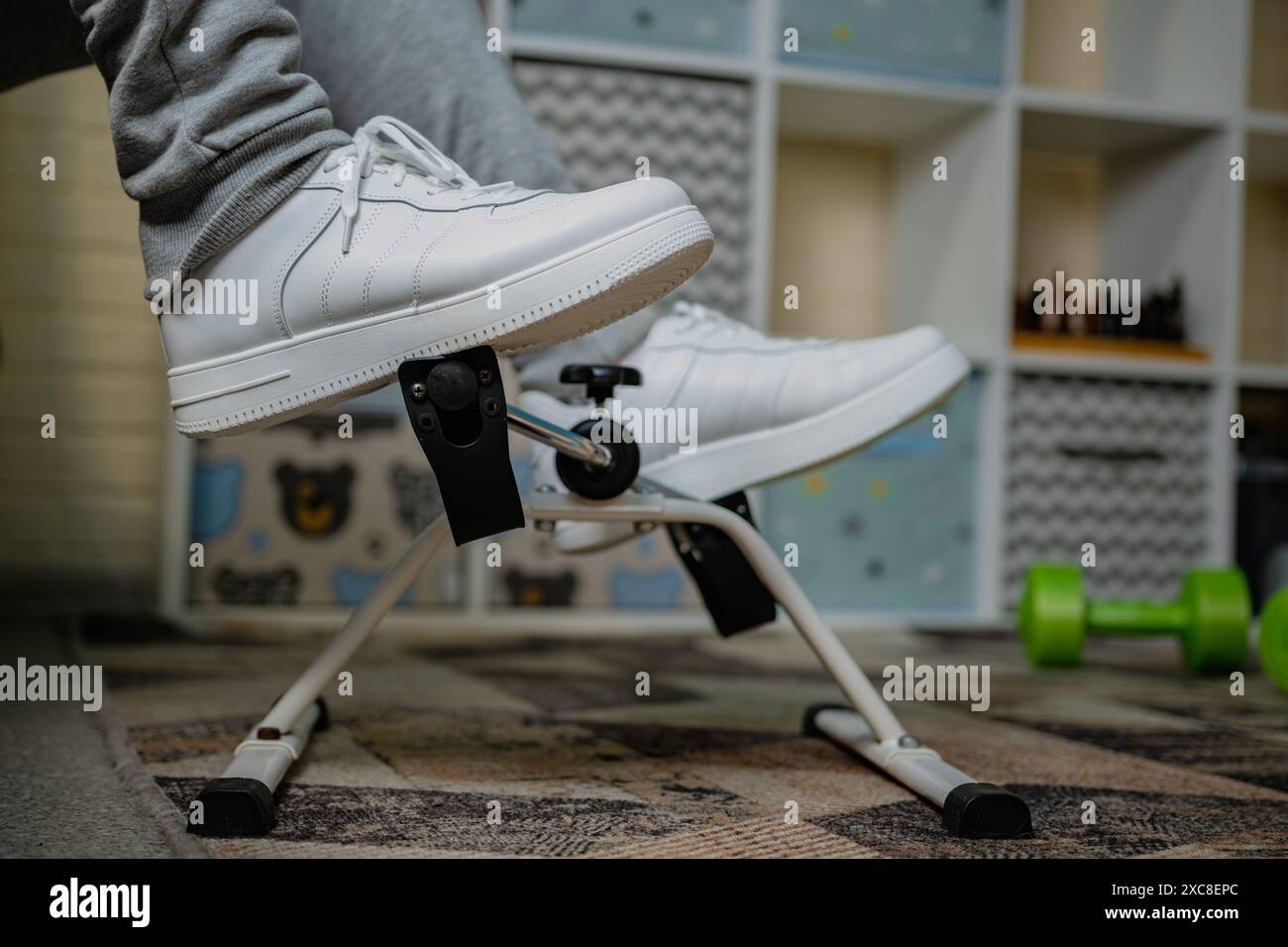 Person Using White Peddler Exercise Machine While Sitting Stock Photo ...