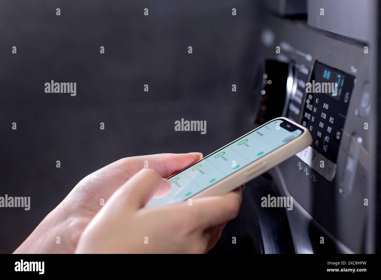 Smartphone with app used to control washing machines Stock Photo - Alamy