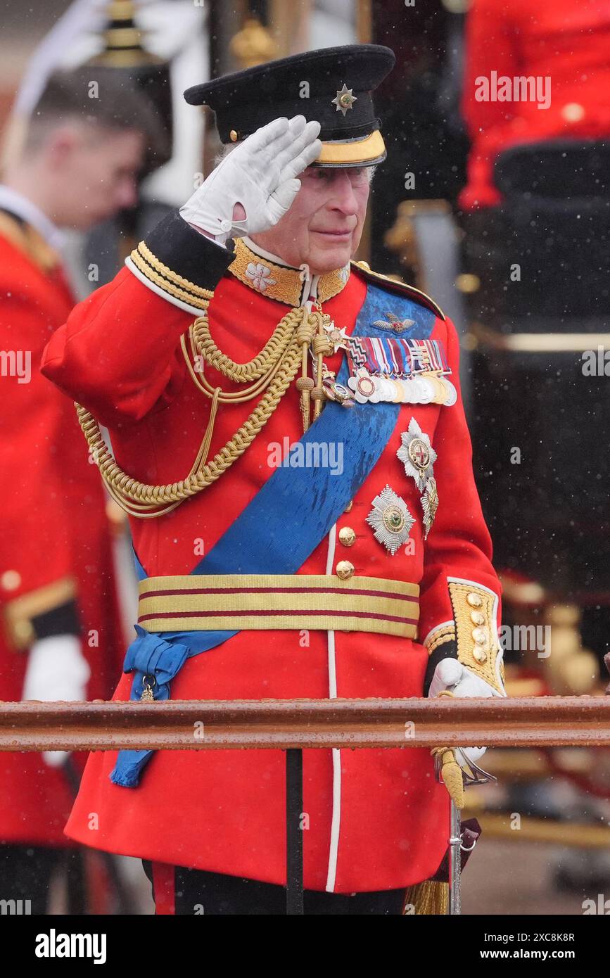 King Charles III salutes outside Buckingham Palace after the Trooping ...