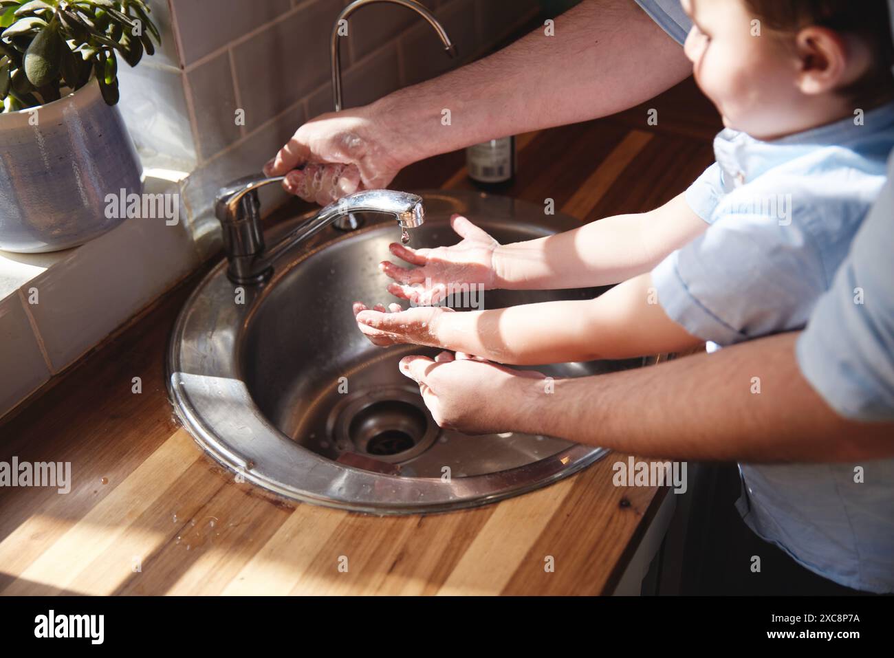 Sink, learning and child washing hands with father in kitchen for ...