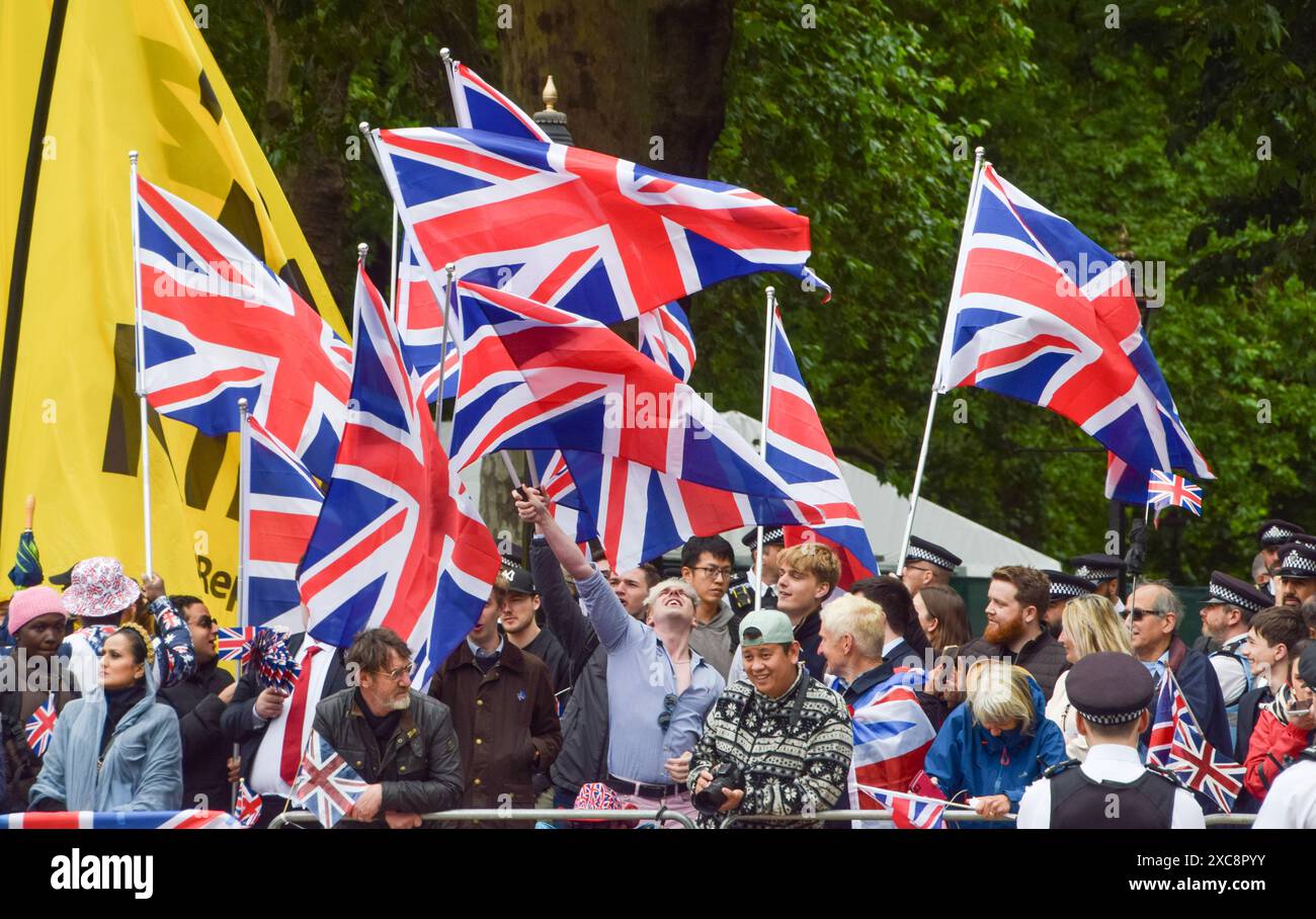 London, UK. 15th June 2024. Royal supporters wave Union Jacks during ...