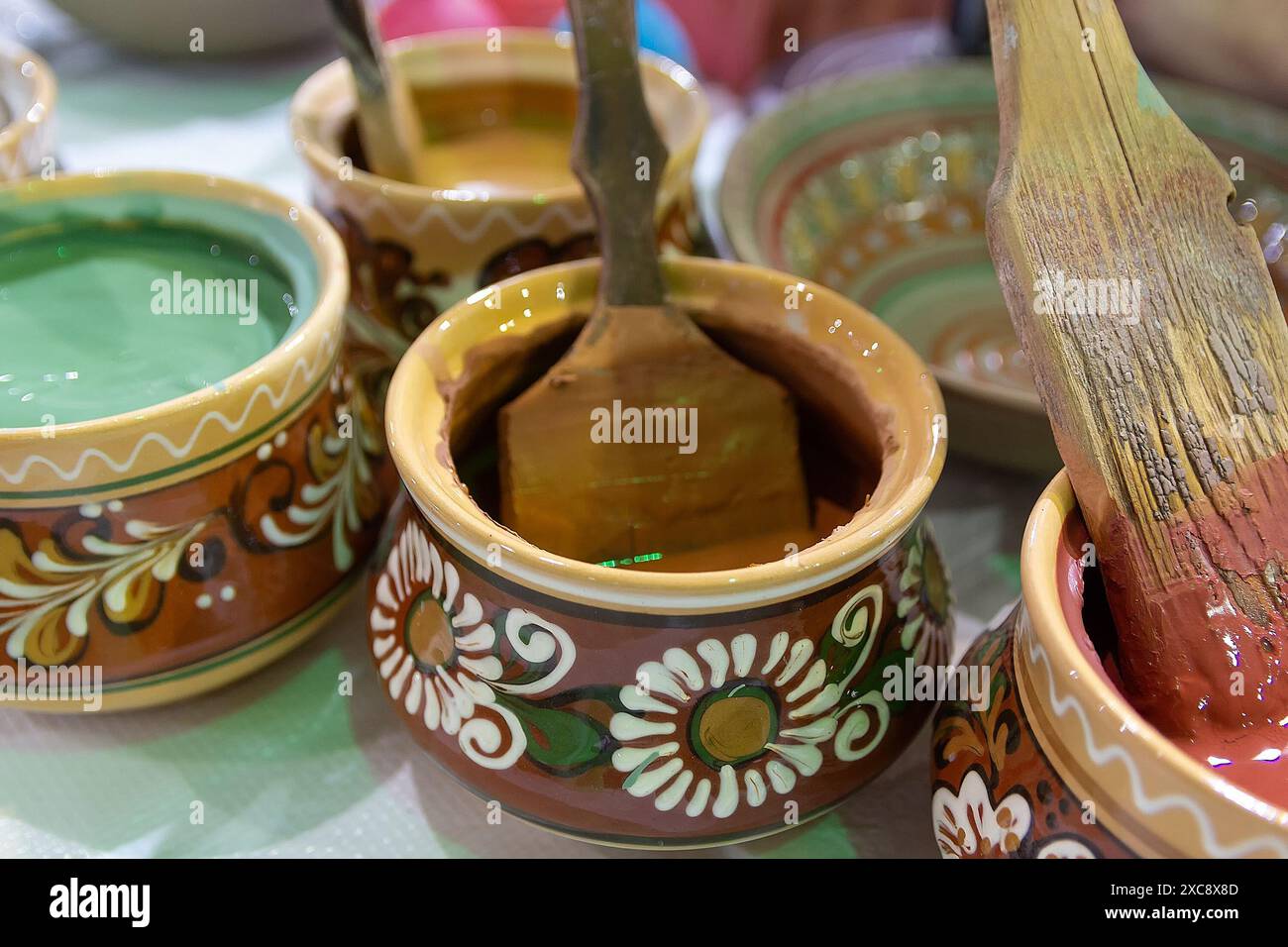 Clay pots hand painted filled with paint. Traditional craft Stock Photo ...