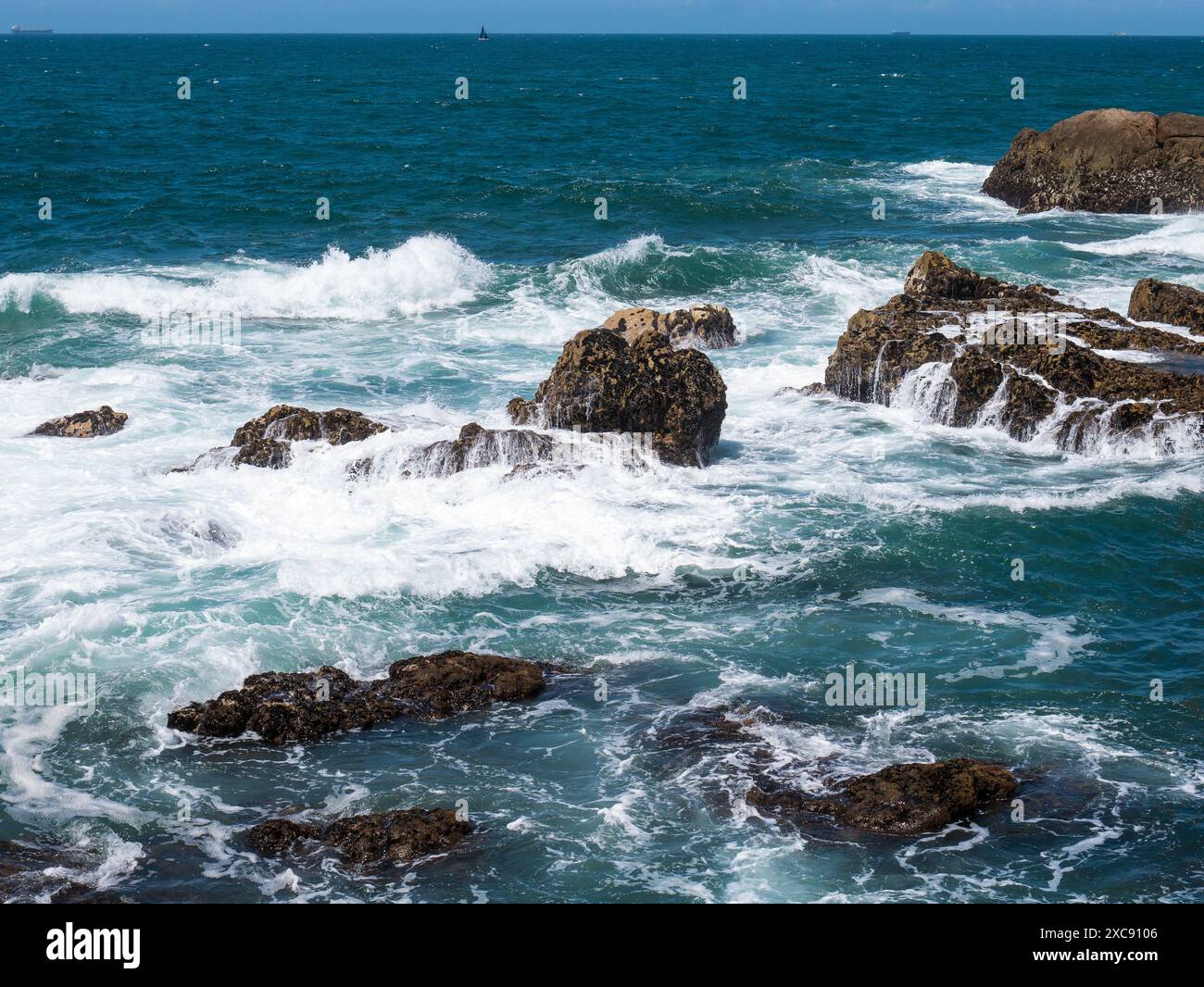 Close up view how Atlantic ocean wave breaks on the big rocky stone ...