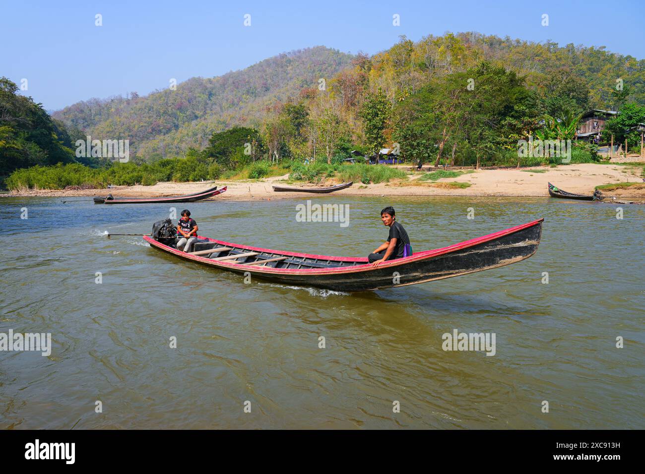Longtail boats on the Pai River crossing towards the Huay Pu Keng long ...