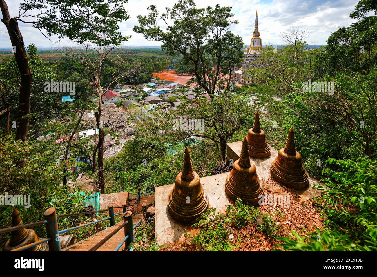 Steep stairs climbing up a limestone karst cliff through the rainforest ...