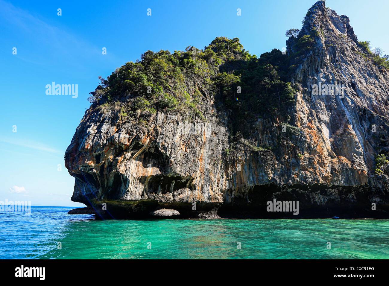 Pi Leh lagoon, surrounded by karstic limestone cliffs, is located on ...