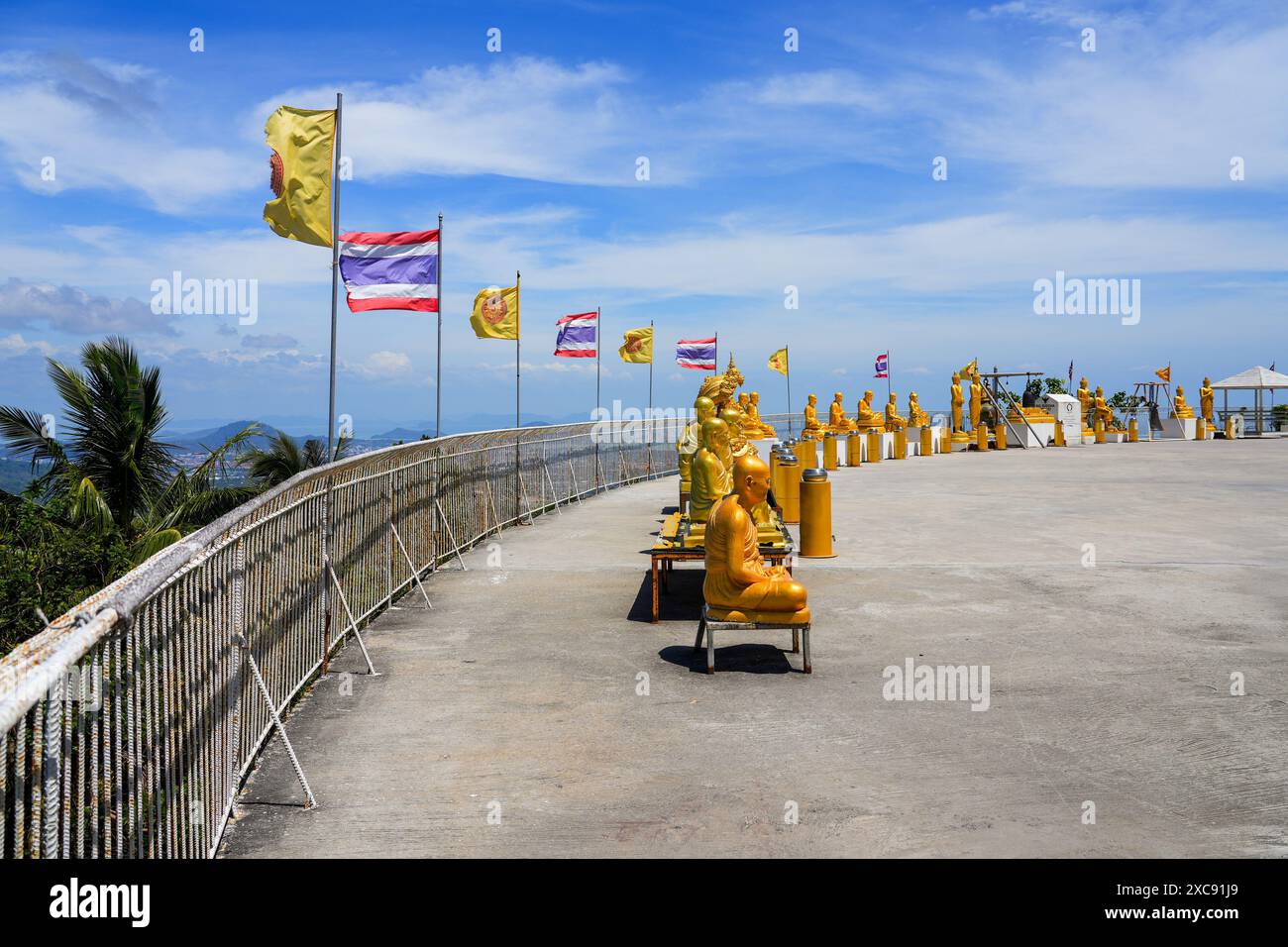 Golden statues of monks on the hilltop platform of the Great Buddha of ...