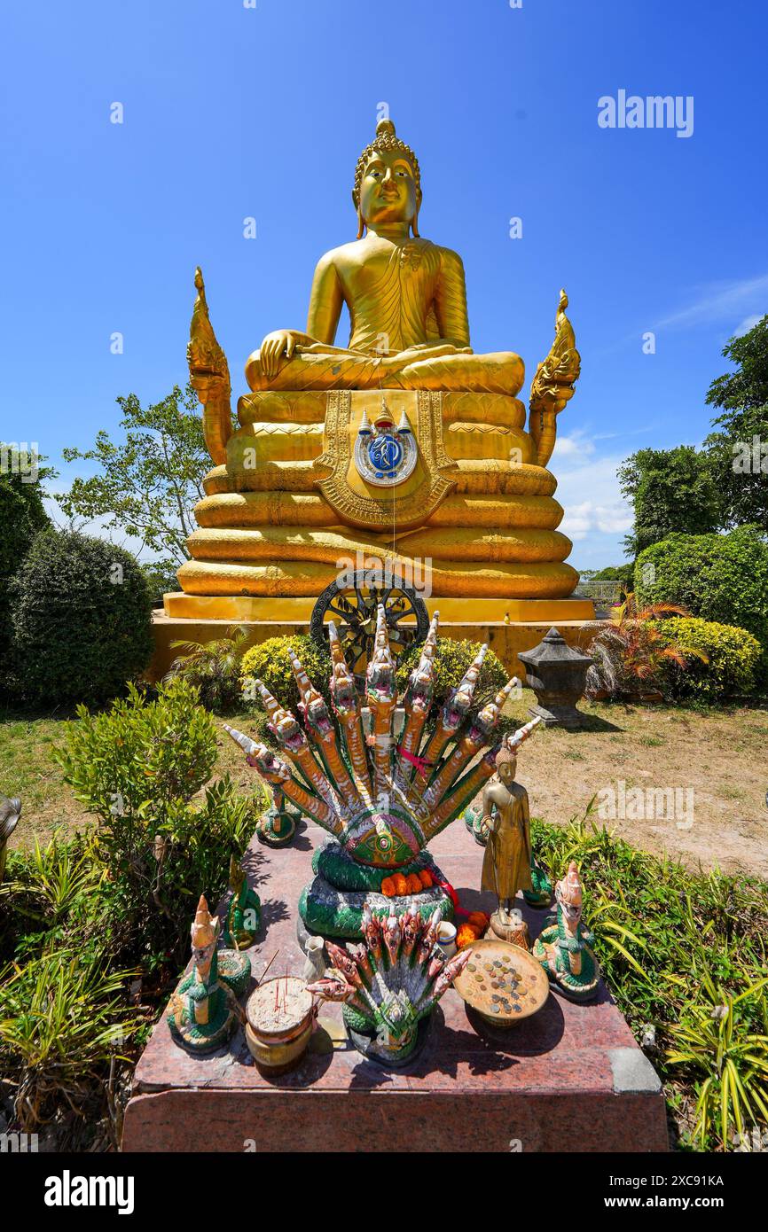 Golden seating Buddha statue located behind the Great Buddha of Phuket ...