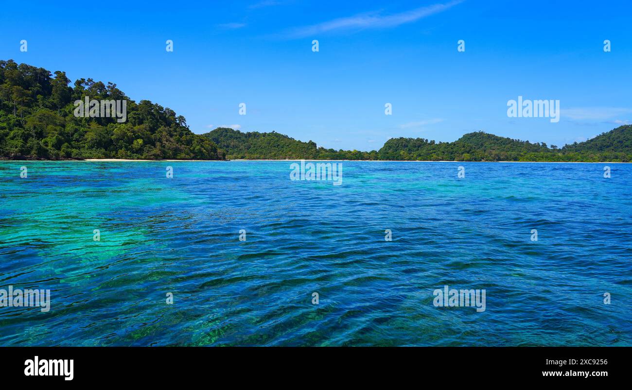 Jungle of Koh Rok Noi island above the transparent turquoise waters of ...
