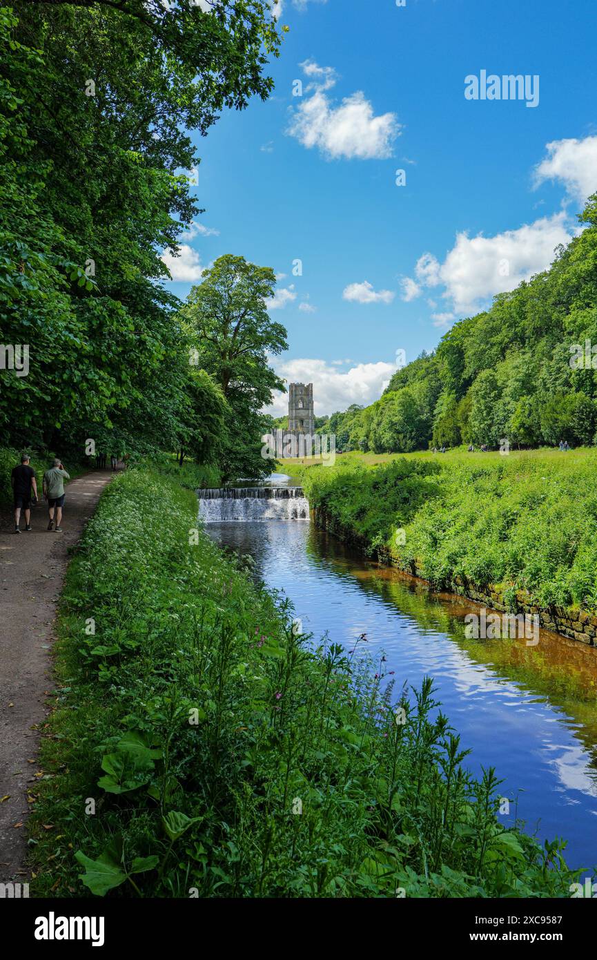 Two male walkers going along by the river skell toward Fountains Abbey ...