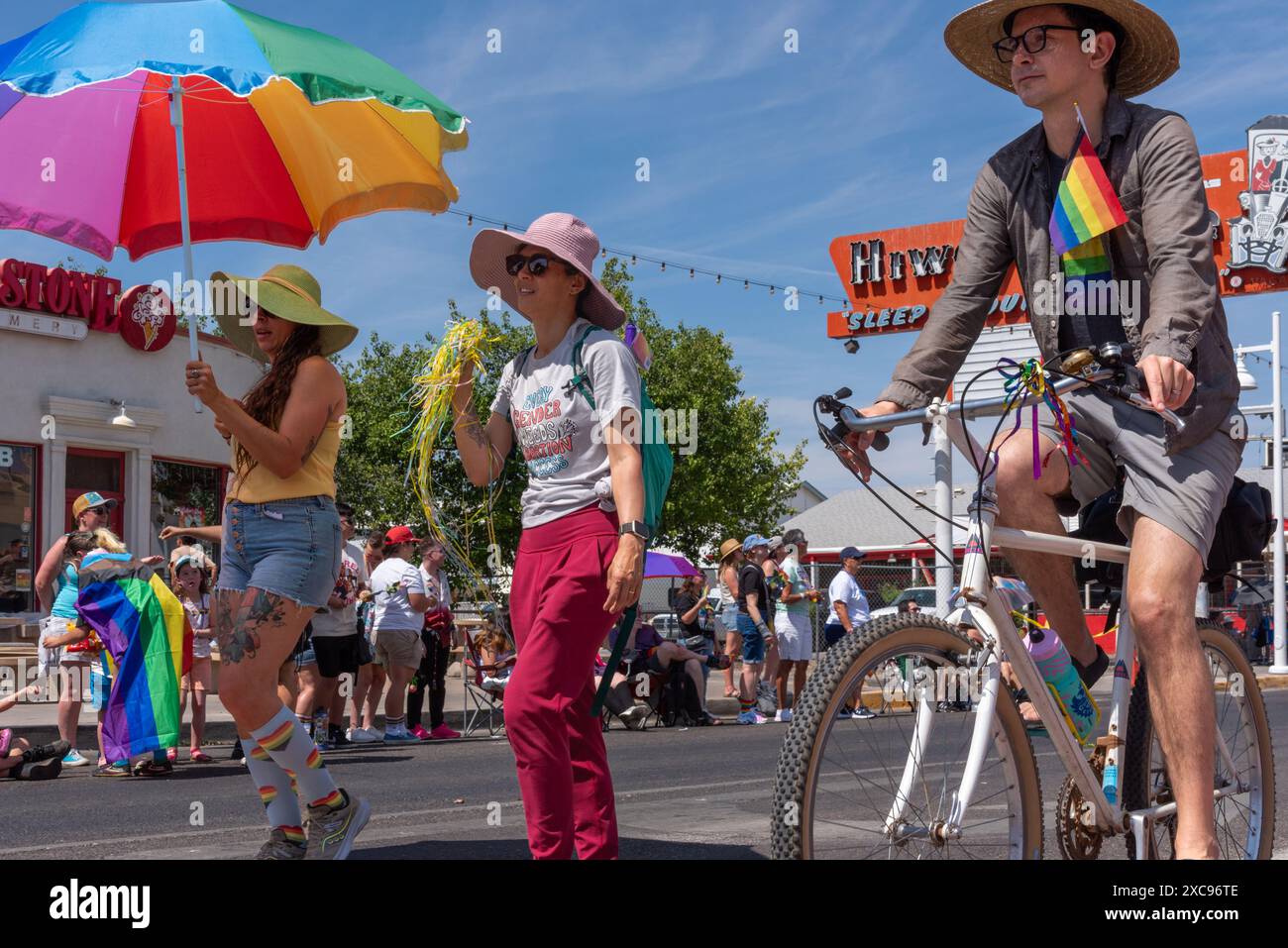 Albuquerque Pride Parade 2024 participants walk and ride a bicycle down ...