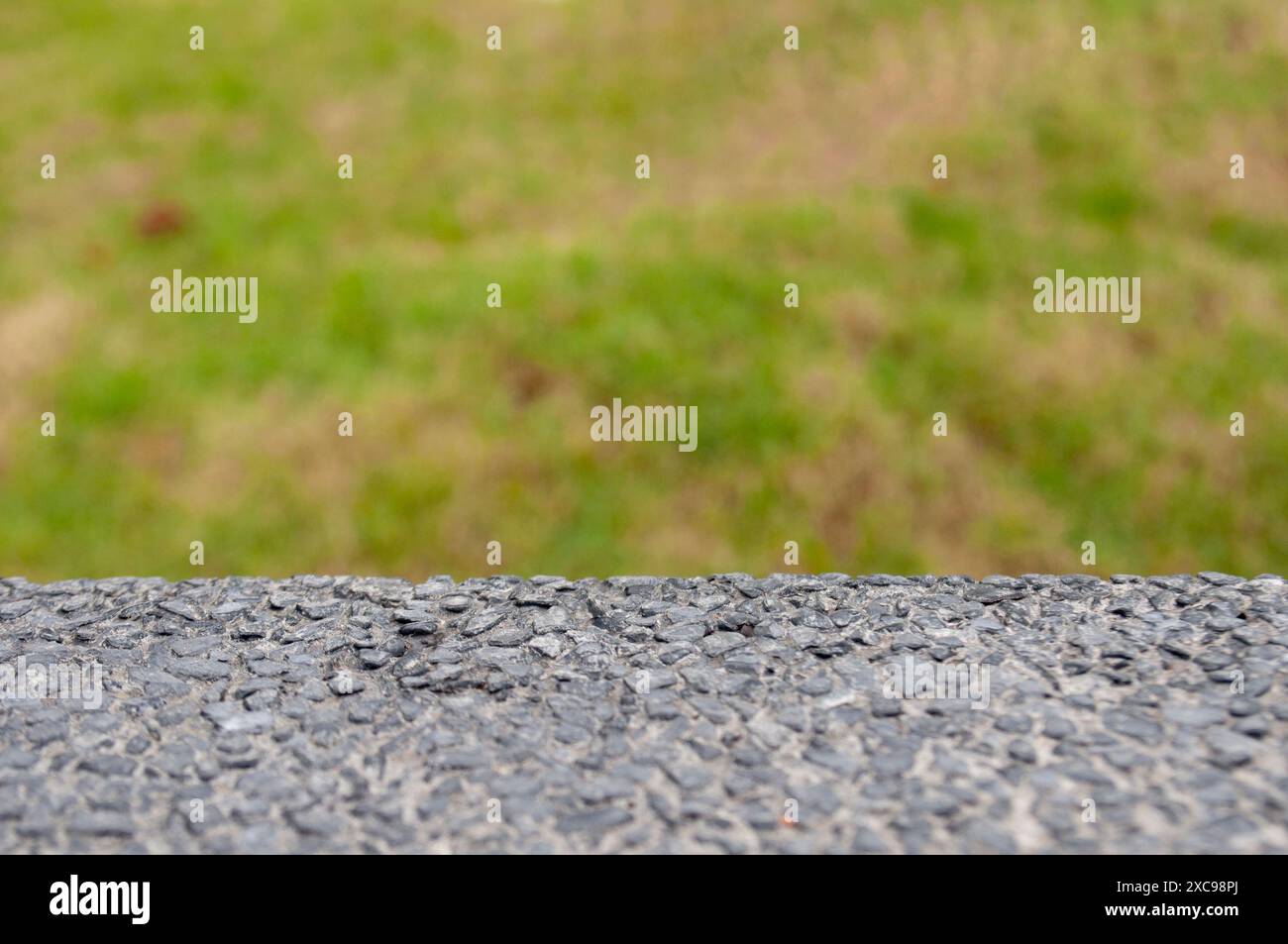Marble table top with grass background with customizable space for mock ...