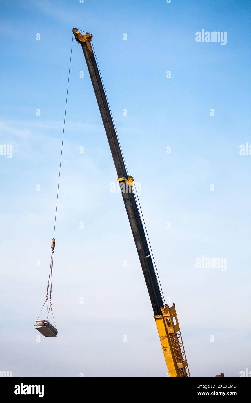 yellow telescopic arms of mobile construction crane truck lifting ...