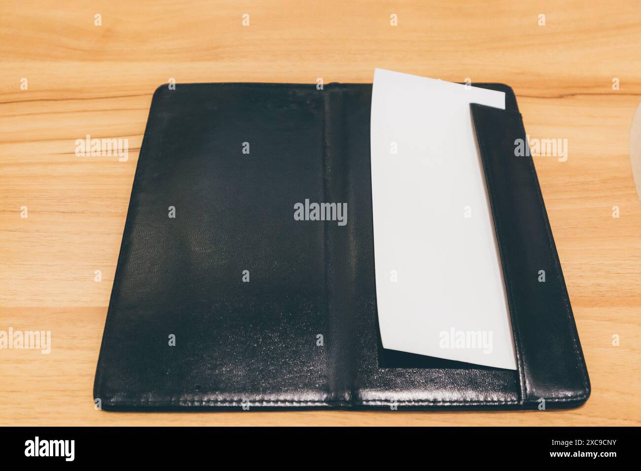 Blank empty white paper in restaurant payment billing receipt folder on ...