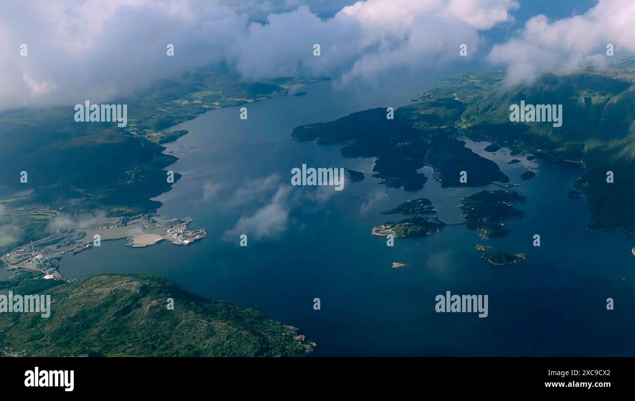Norway. 15th June, 2024. Aerial view through the clouds to the sea bay ...
