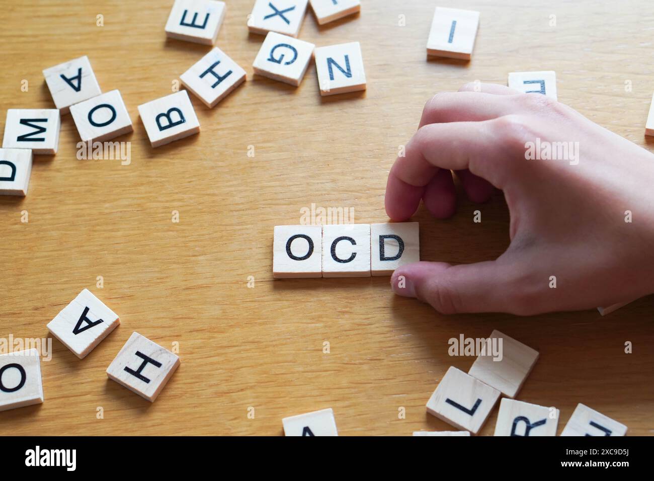hand placing the letters OCD Obsessive compulsive disorder Stock Photo ...