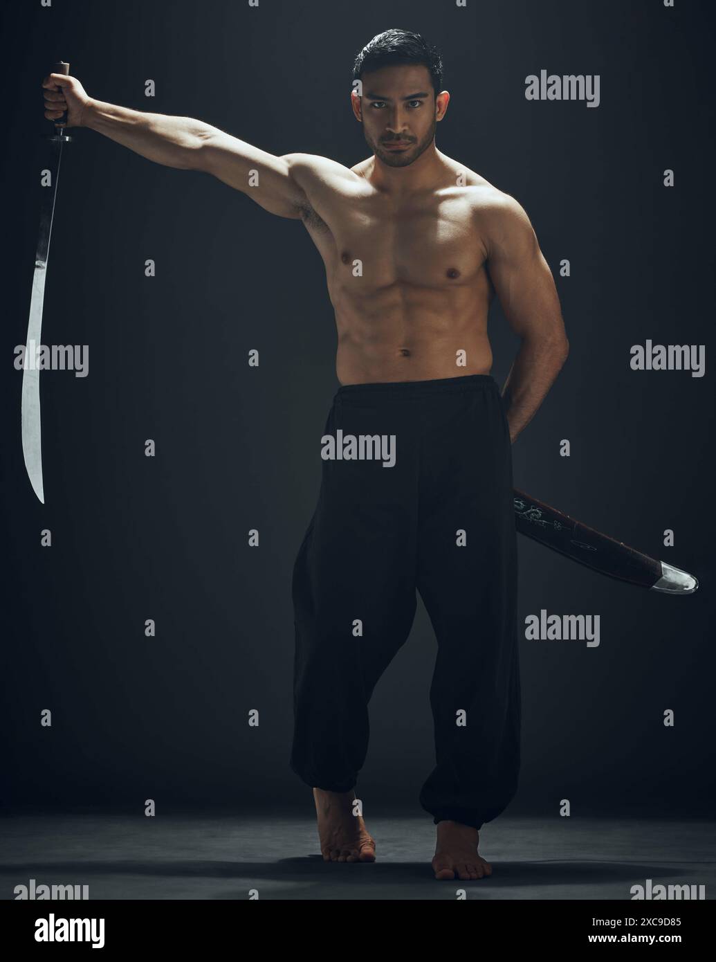 Portrait, samurai sword and Asian man in studio for training, exercise ...