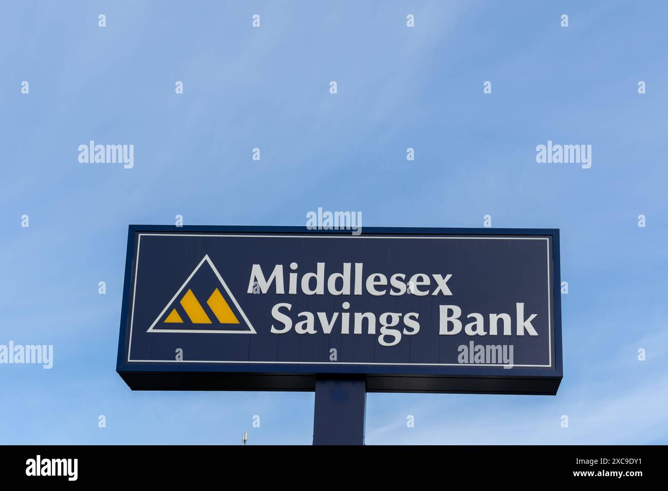 A Middlesex Savings Bank pole sign with the blue sky background ...