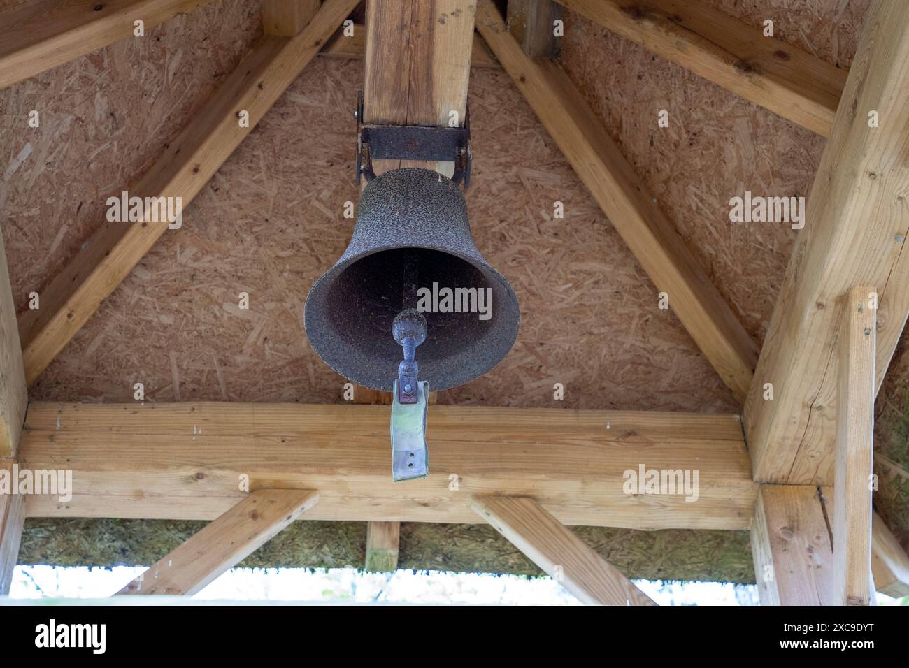 Rusty metal bell hanging from wood ceiling Stock Photo - Alamy