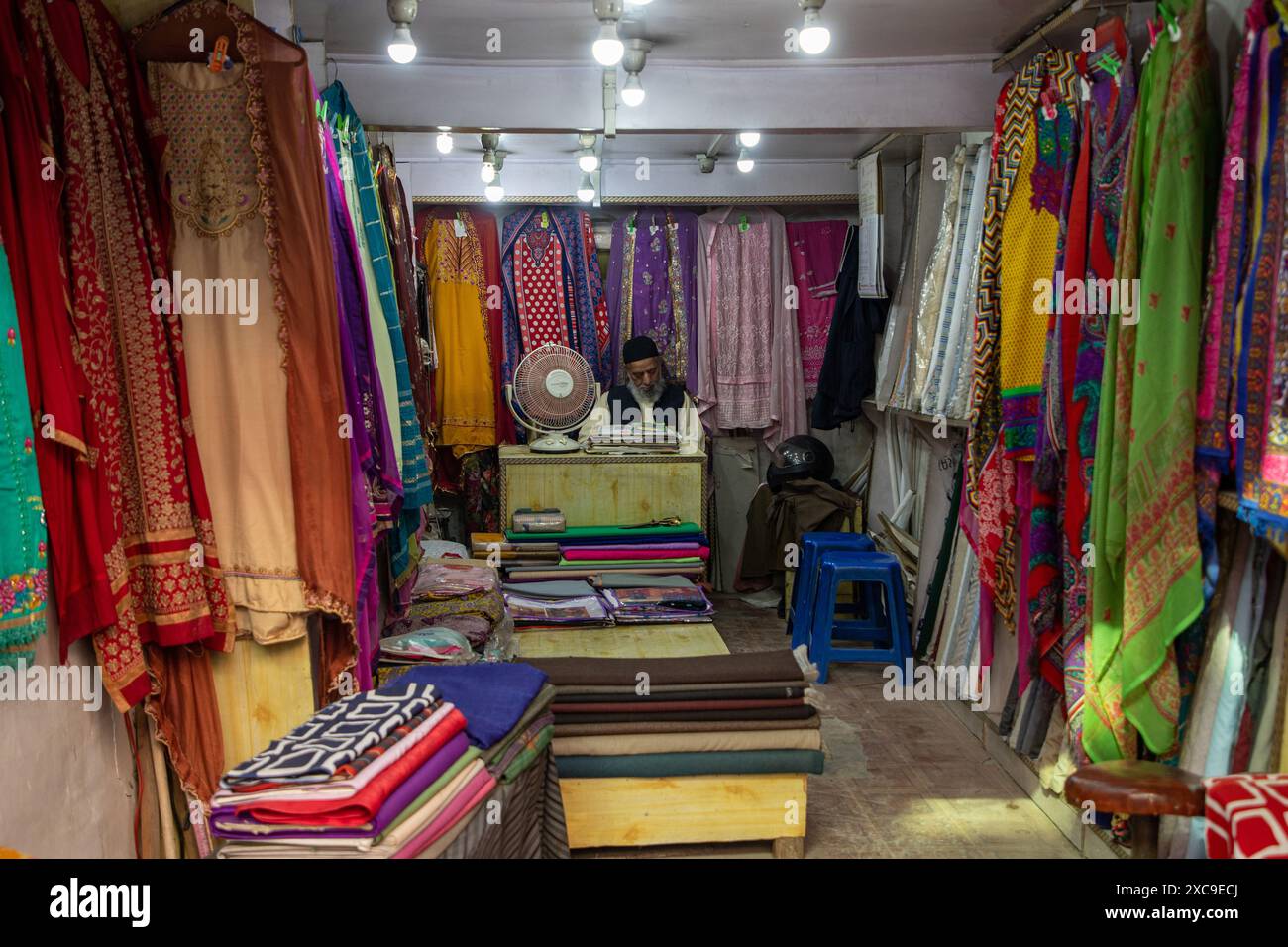 Srinagar, India. 15th June, 2024. Kashmiri shopkeeper waits for ...