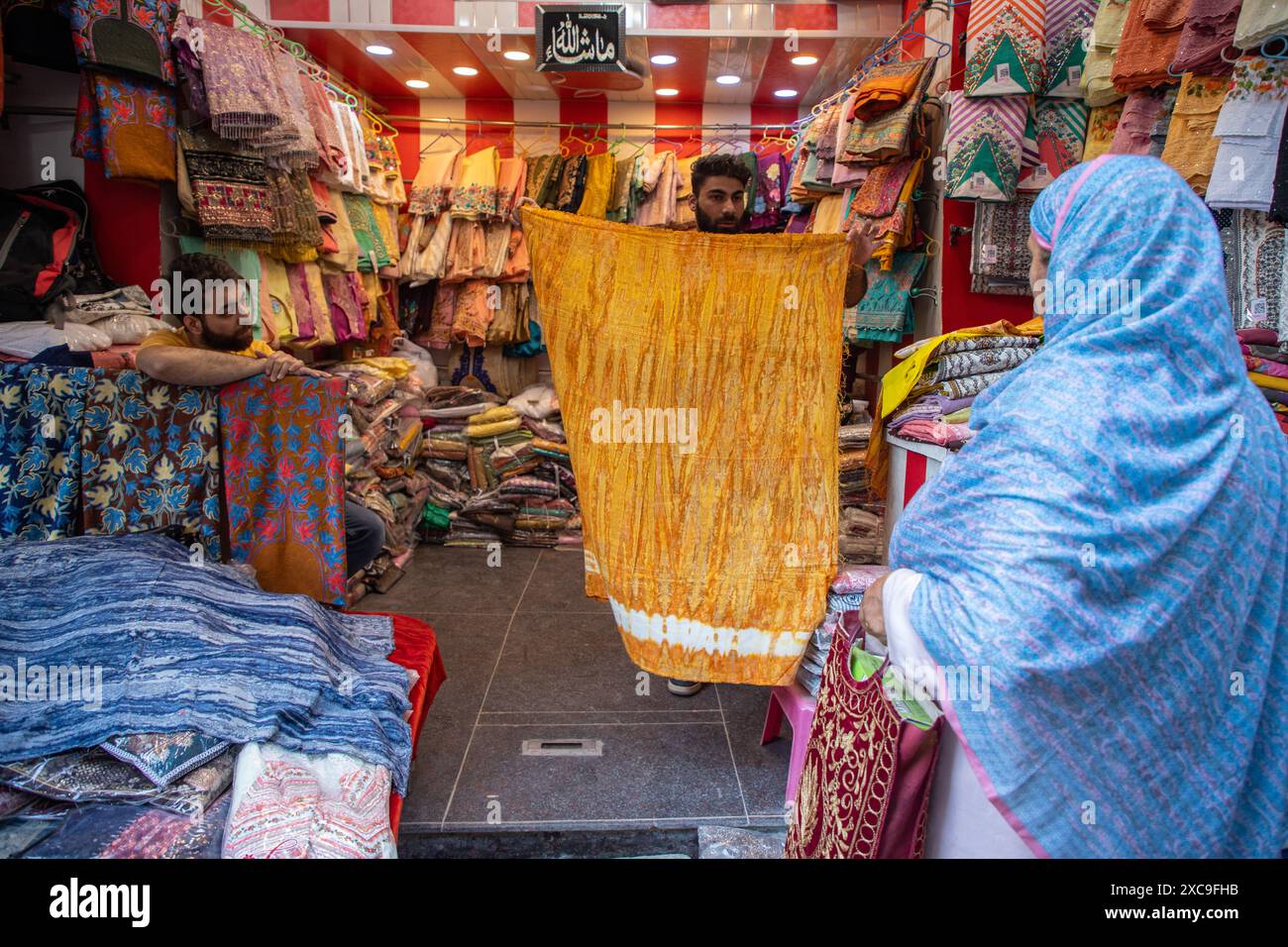 Srinagar, India. 15th June, 2024. Kashmiri people shop ahead of the ...