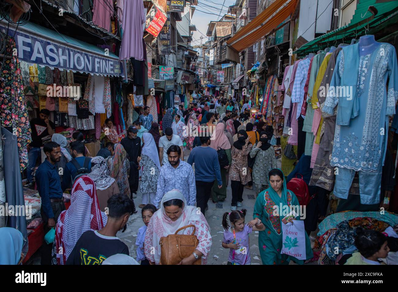 Srinagar, India. 15th June, 2024. Kashmiri people shop ahead of the ...
