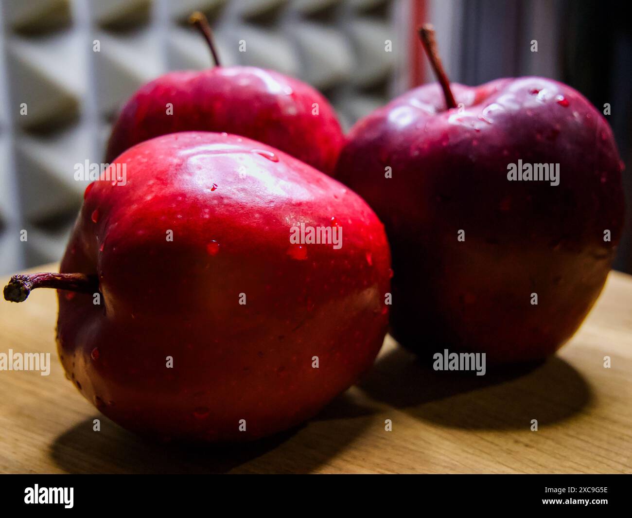 Glossy Apples: Apples with a shiny finish against a dark patterned ...