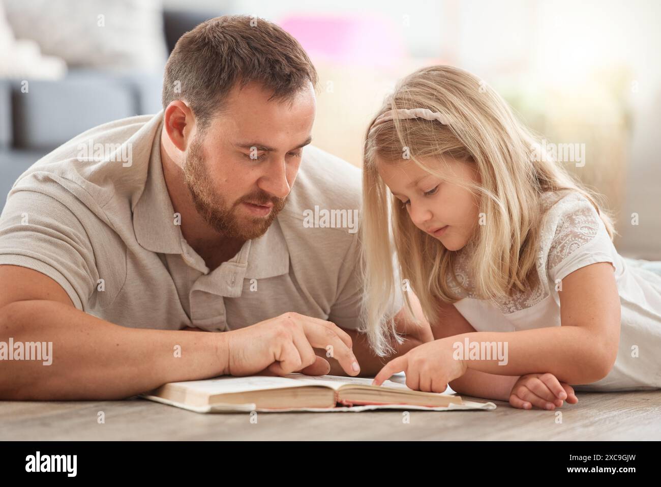Reading, book and father with child on floor for relaxing, bonding and ...
