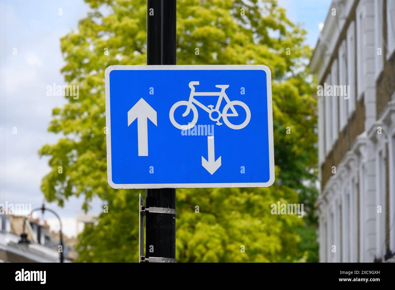 London, UK. Sign in a Camden one-way street showing that cyclists can ...