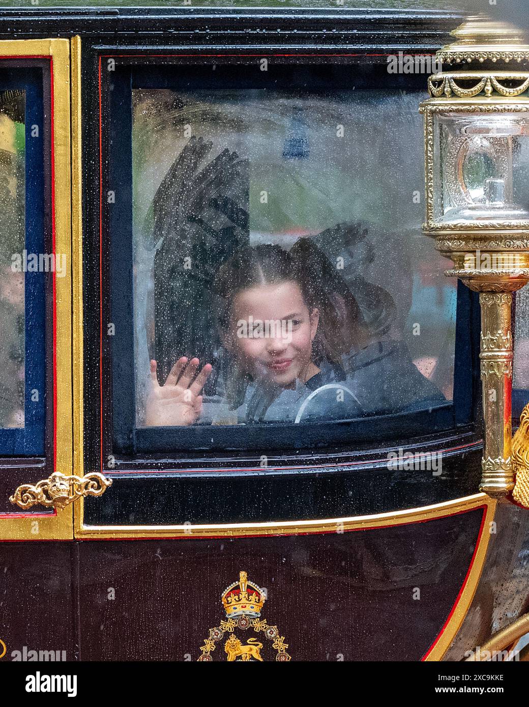 London, UK 15th Jun 2024. Princess Charlotte waves to crowds through a ...