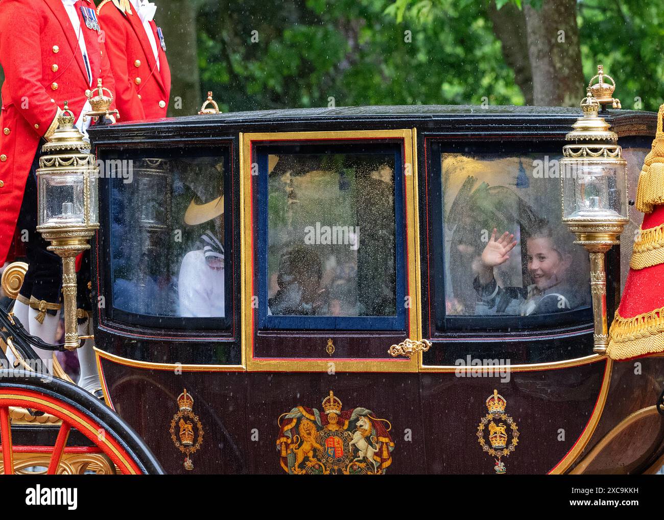 London, UK 15th Jun 2024. Princess Charlotte waves to crowds through a ...