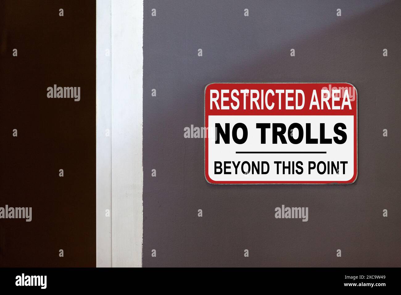 Red and white restricted area sign on the side of an open door stating ...