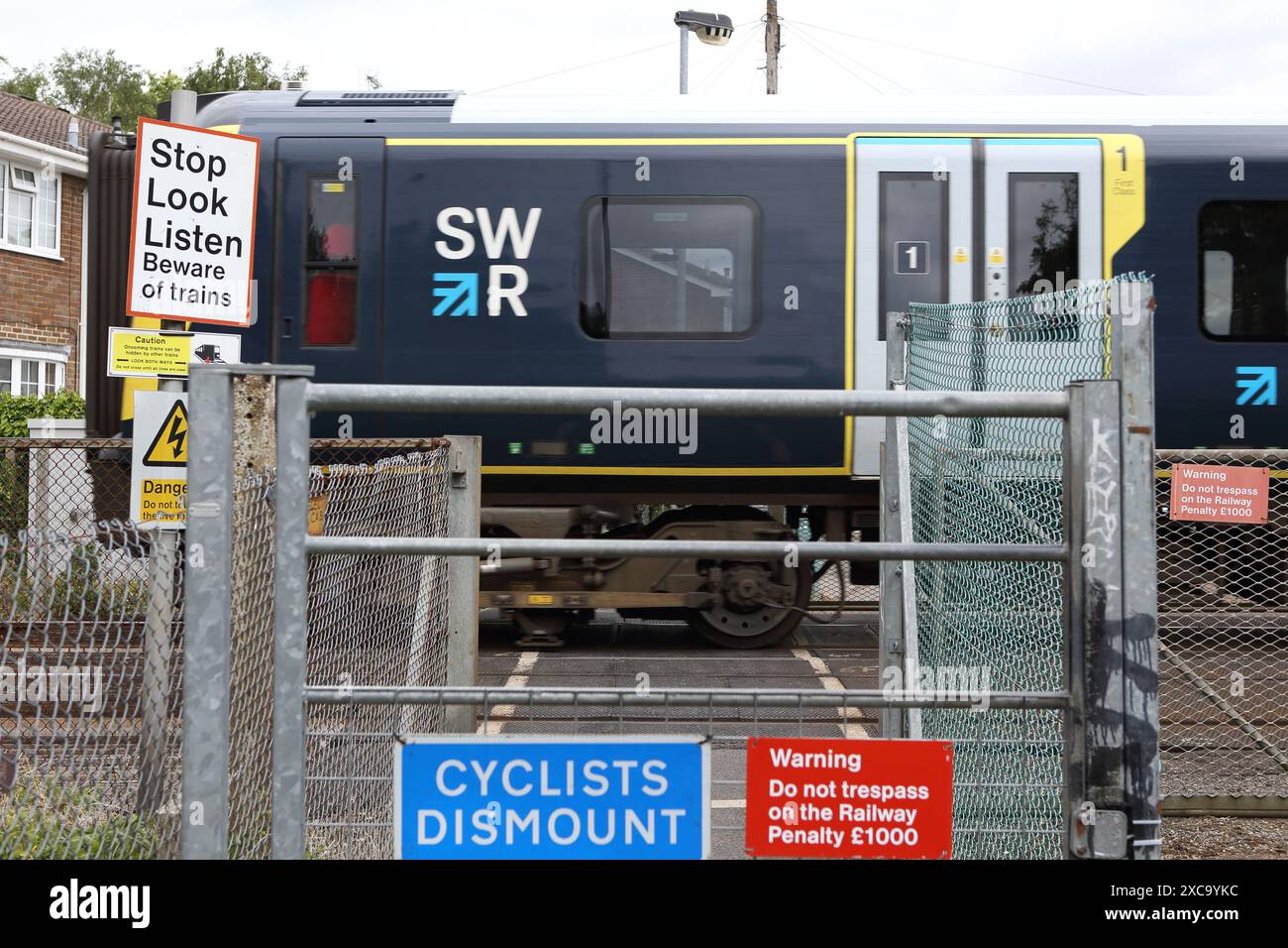 Railway foot crossing Frimley Green Hampshire UK with warning signs ...